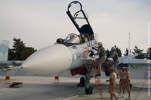 Russian pilots climb to their Su-30 jet at Hemeimeem airbase, Syria ...